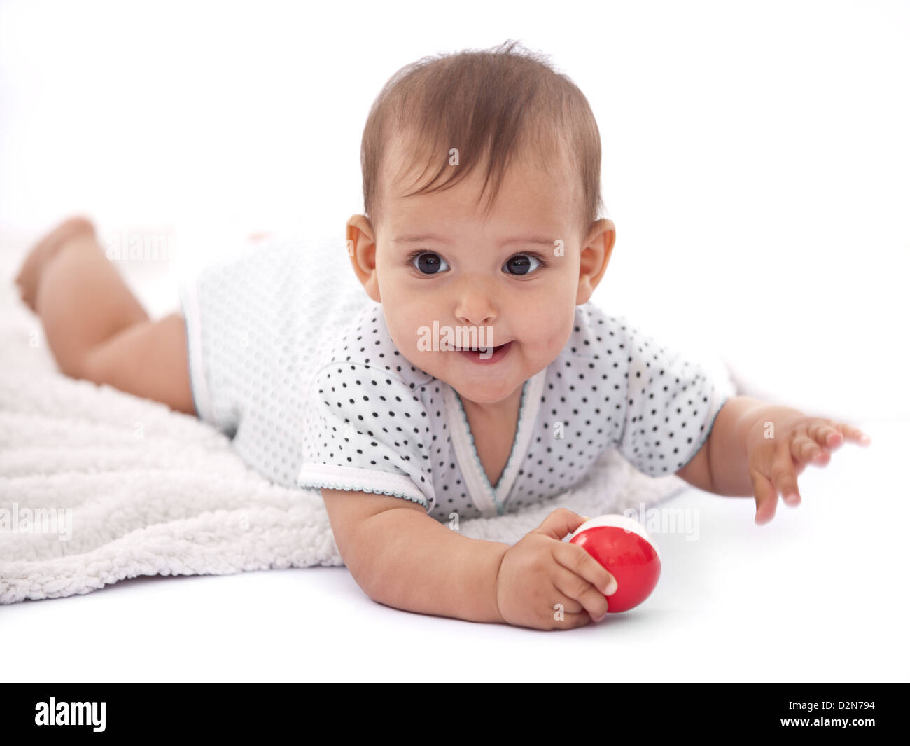 Little baby girl with small ball laying on the floor Stock Photo - Alamy