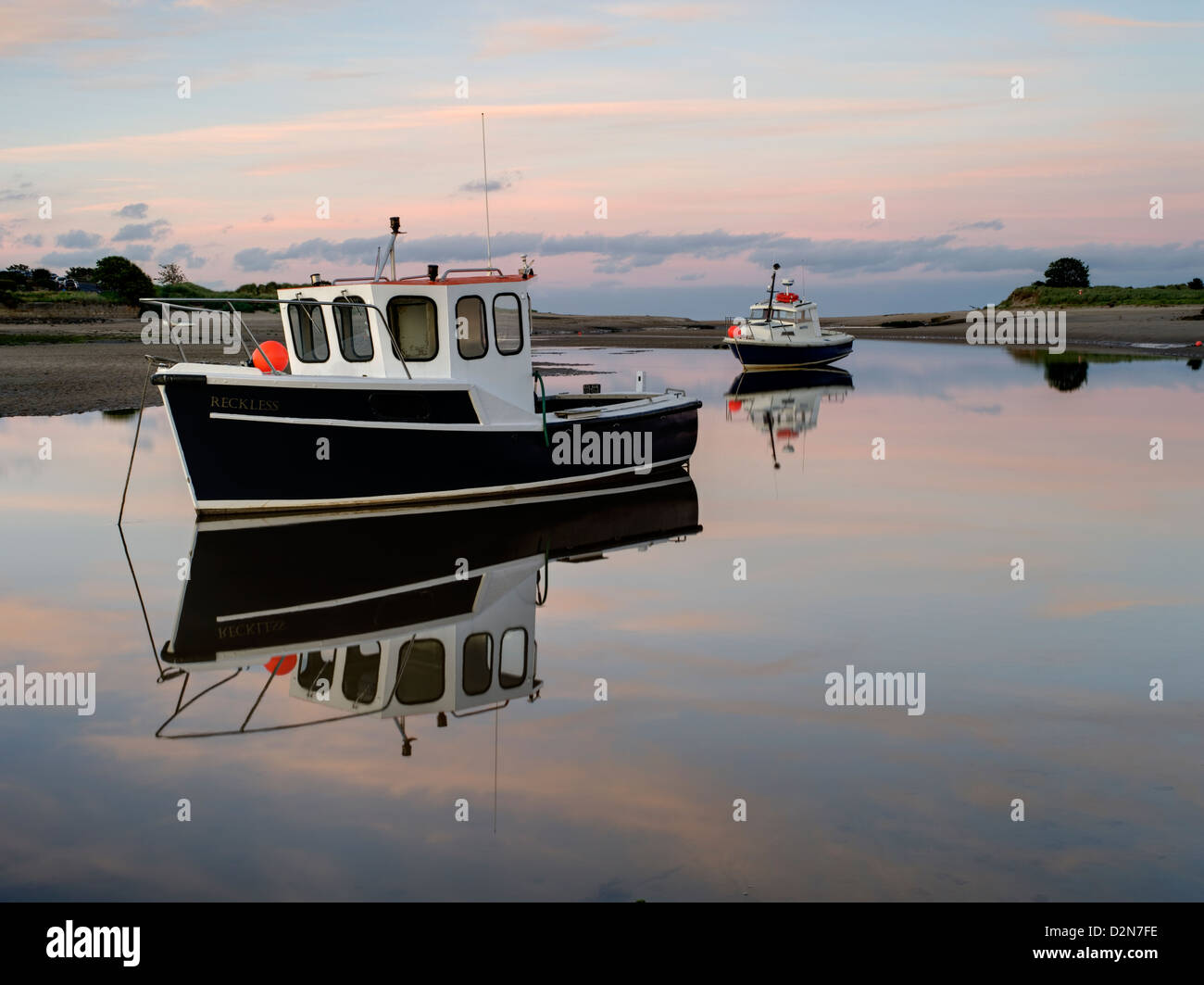 Looking across the Aln Estuary to Alnmouth village at sunset on the ...