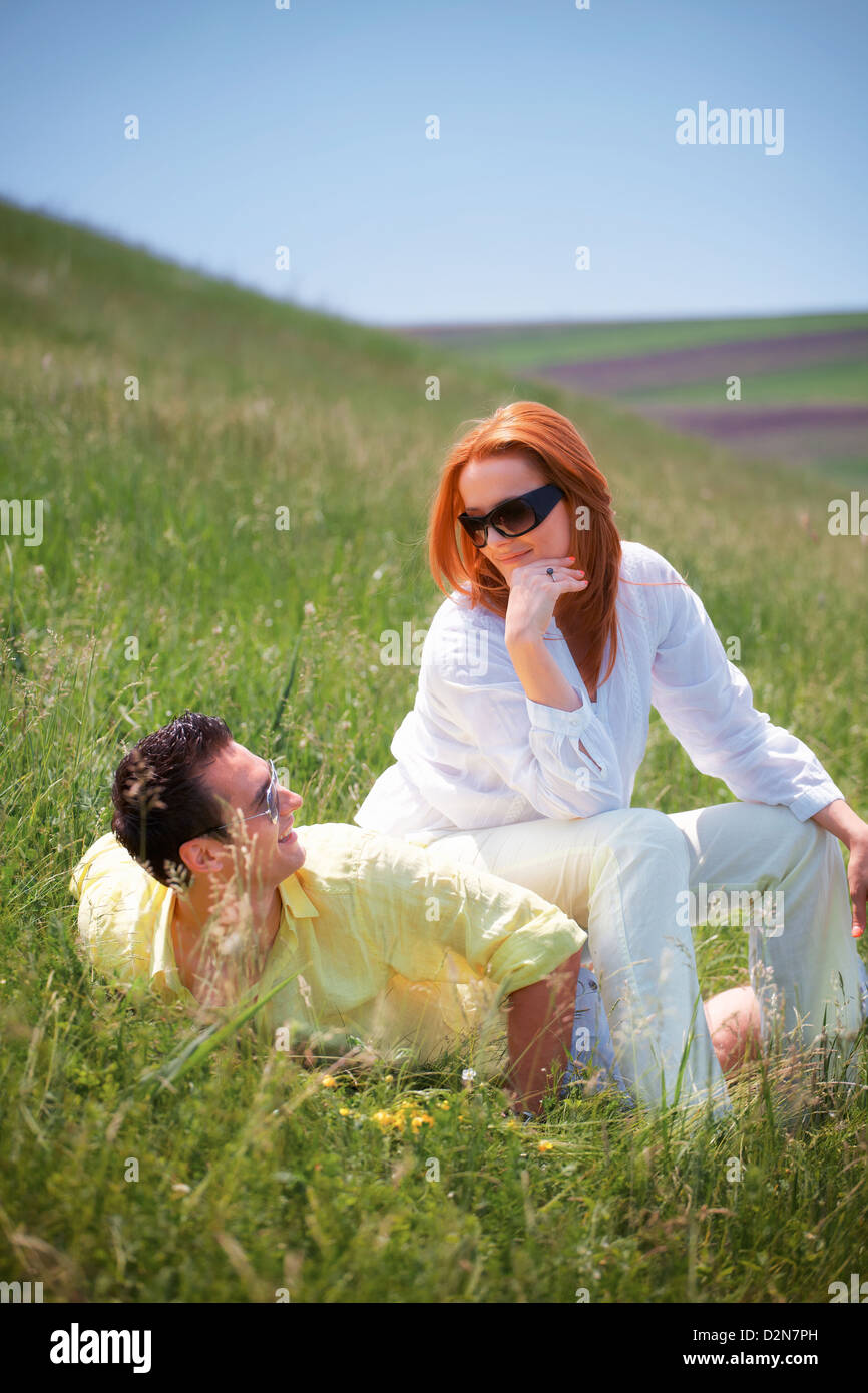 Conceptual image with woman sitting on the man, portrait outdoor Stock ...