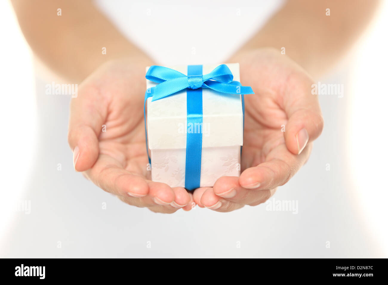 Closeup of decorative gift box tied with a turquoise ribbon and bow ...