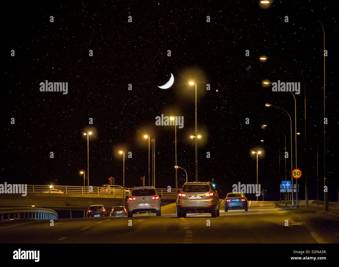 Crescent moon and starry night over the highway, Reykjavik Iceland ...