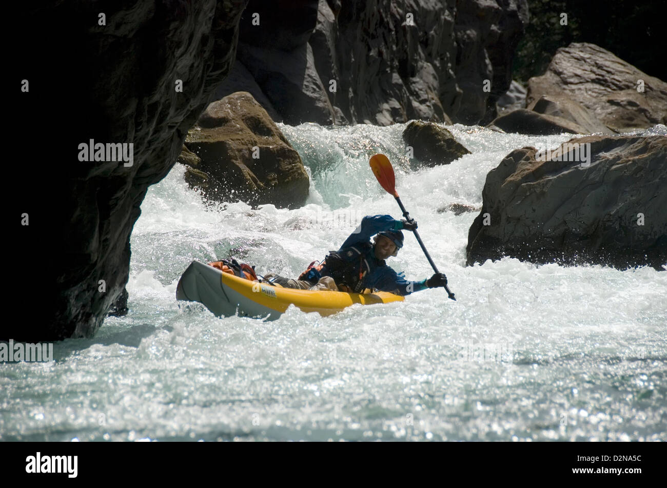 Paddling an inflatable kayak down Green Wall Rapid on the Illinois ...