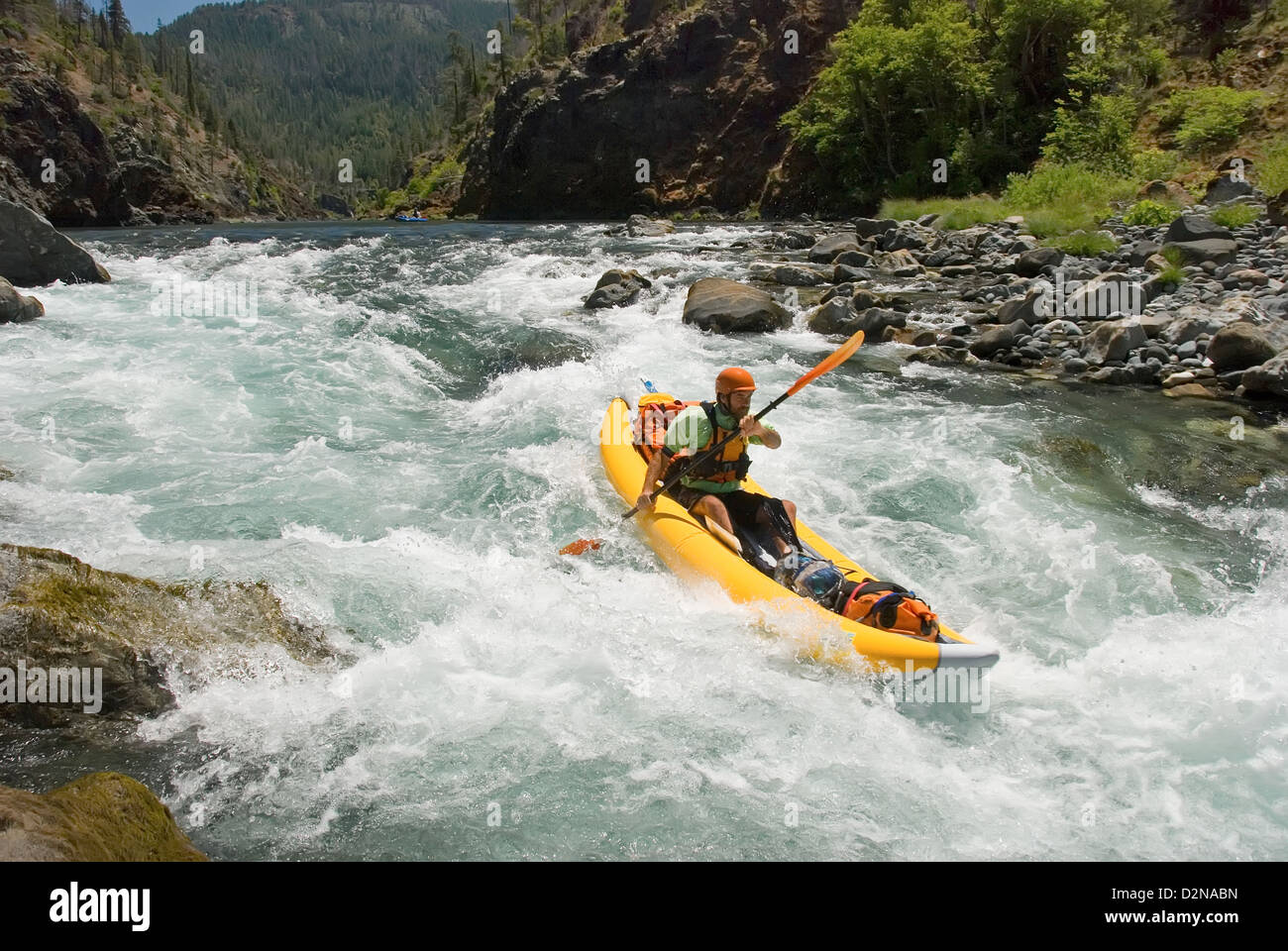 Paddling an inflatable kayak down a rapid on the Illinois River in ...
