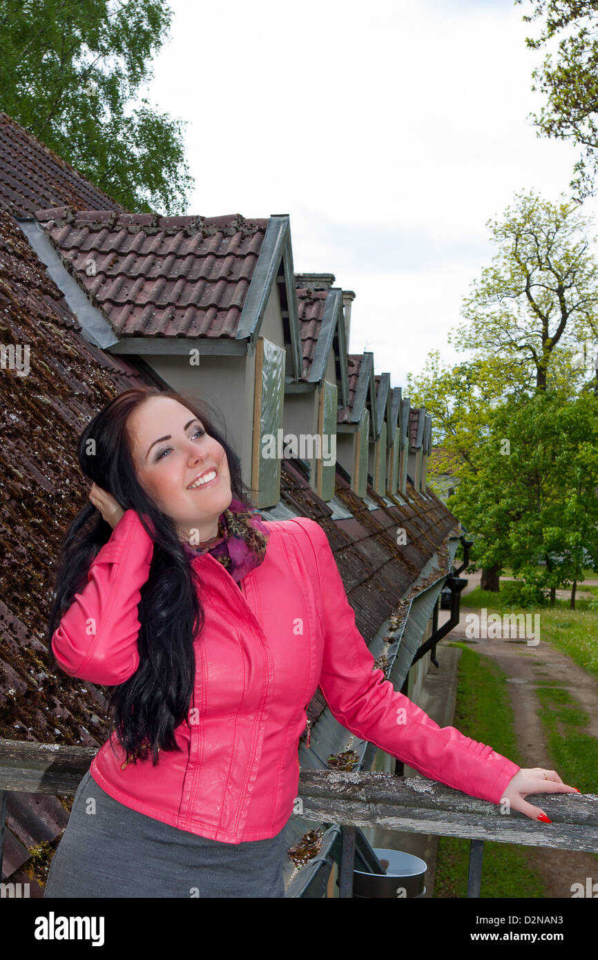 A beautiful girl standing on the balcony Stock Photo - Alamy