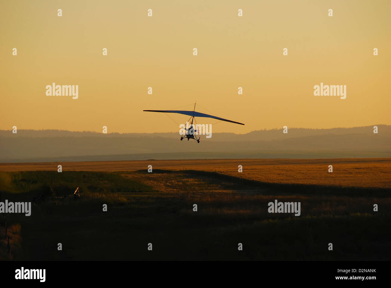 Landing an ultralight aircraft at sunset on a prairie in Southeast ...