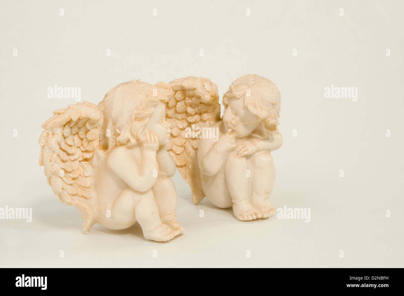 two angels on a white background Stock Photo - Alamy