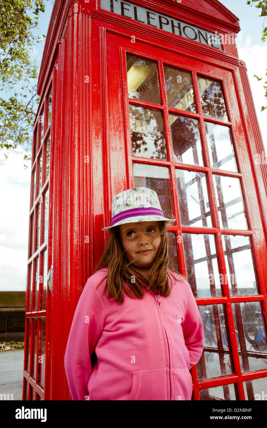 Portrait of the girl in front the red telephone booth Stock Photo - Alamy