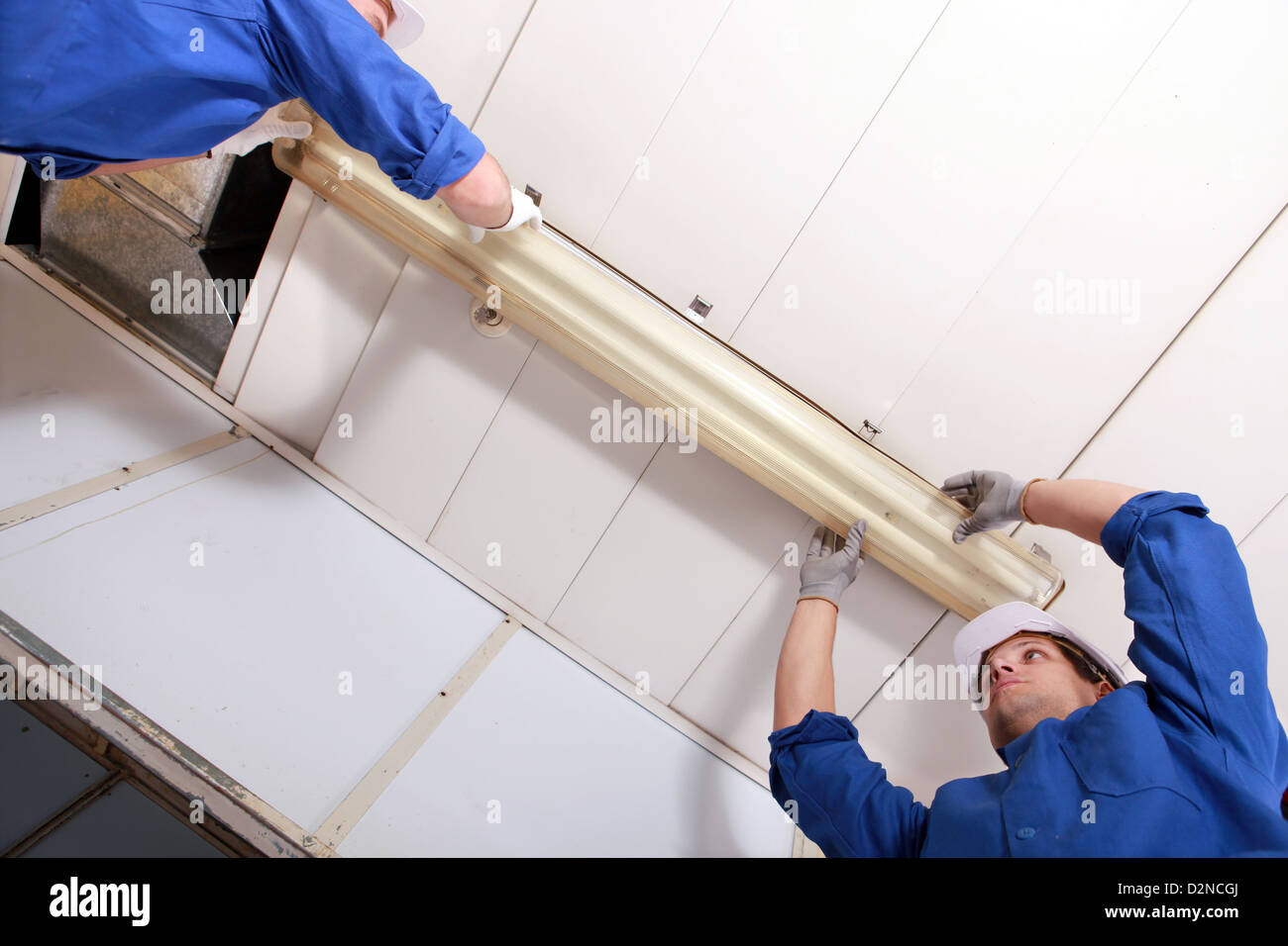 Men installing neon Stock Photo - Alamy