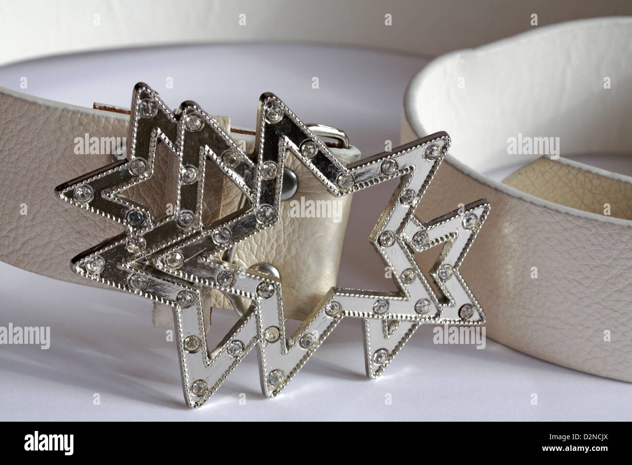 White belt with sparkling stars buckle set on white background Stock ...