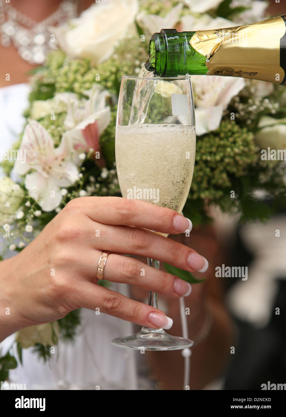 Glass of champagne in a hand of the bride Stock Photo - Alamy