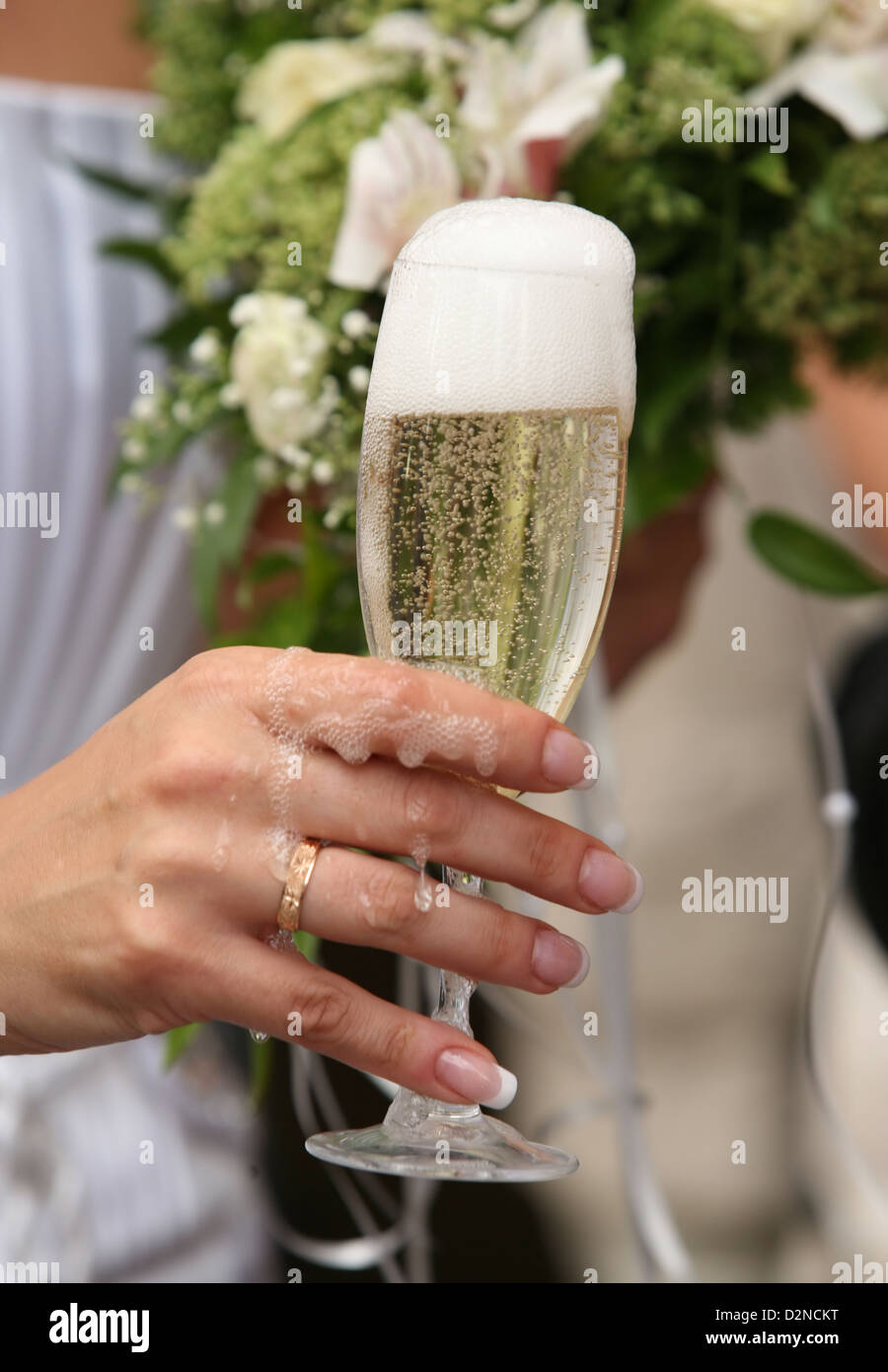 Glass of champagne in a hand of the bride Stock Photo - Alamy