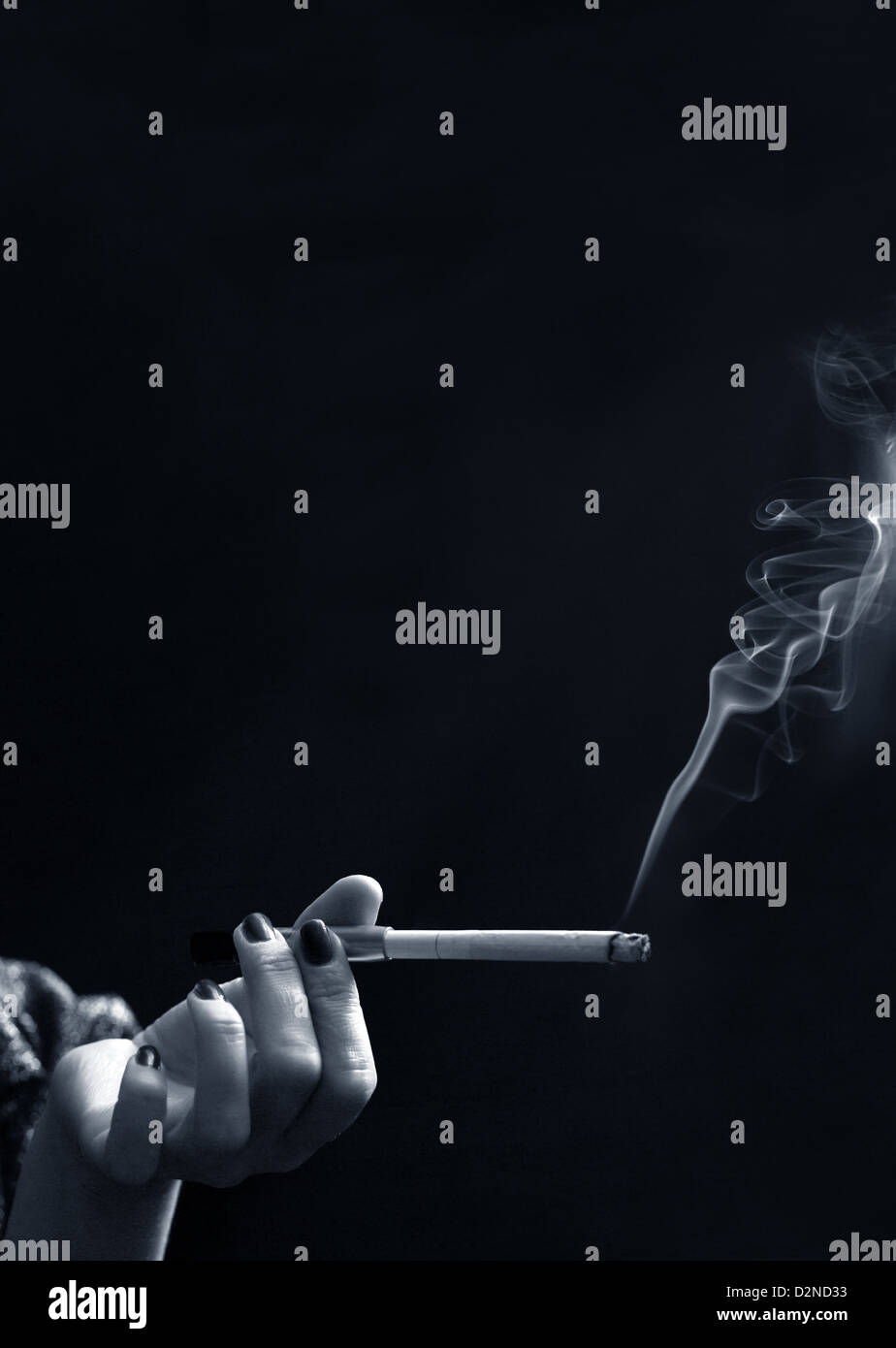 Hand with a cigarette with a smoke Stock Photo - Alamy
