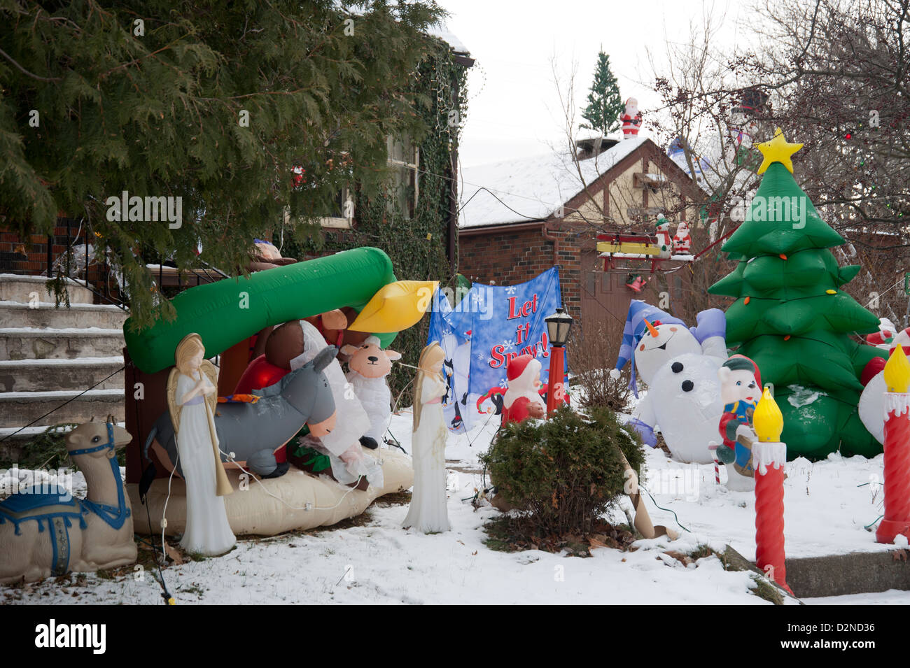 Inflatable Christmas ornaments litter a front yard of a house Stock ...