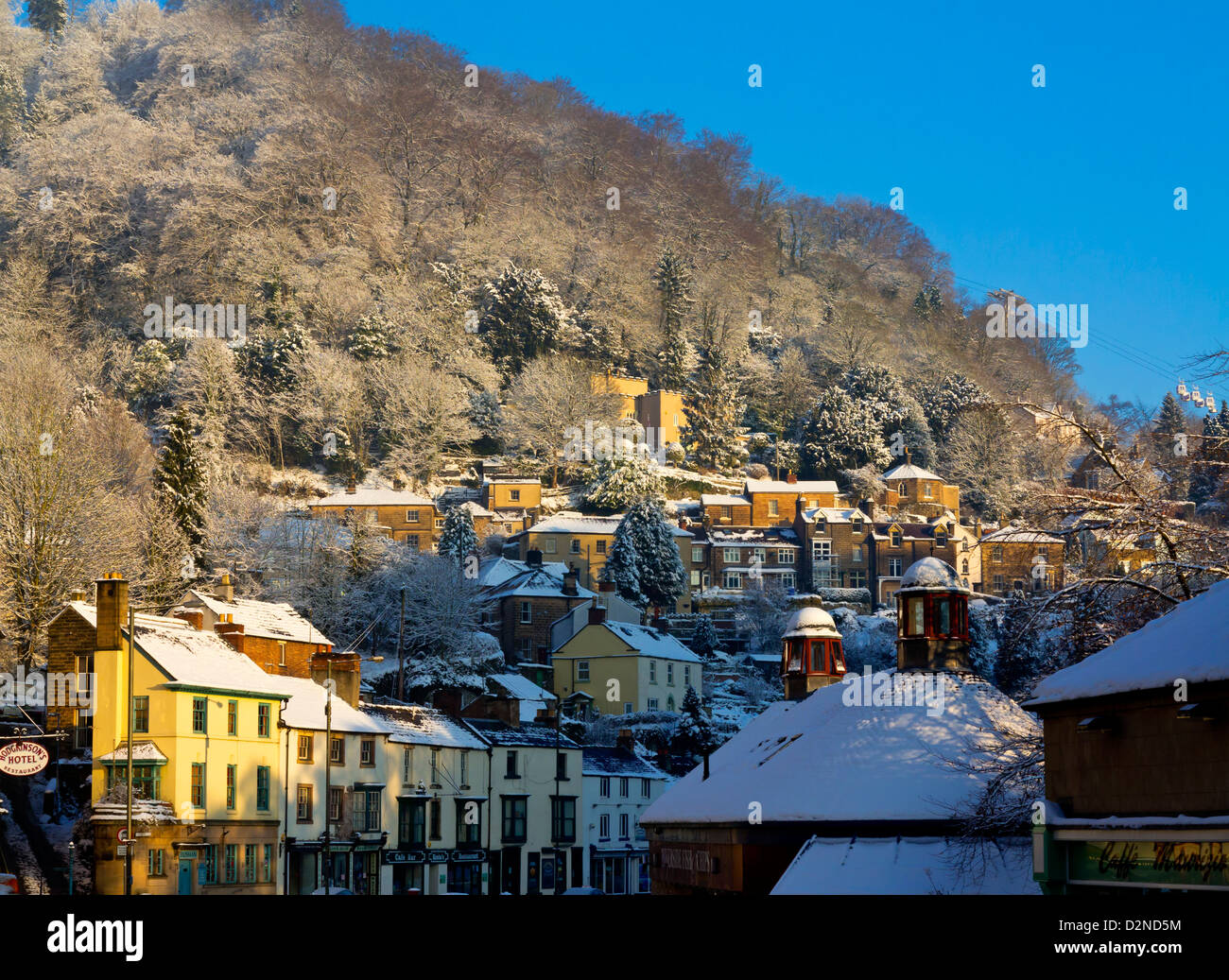 Snow covered houses and shops in Matlock Bath a popular village in the ...