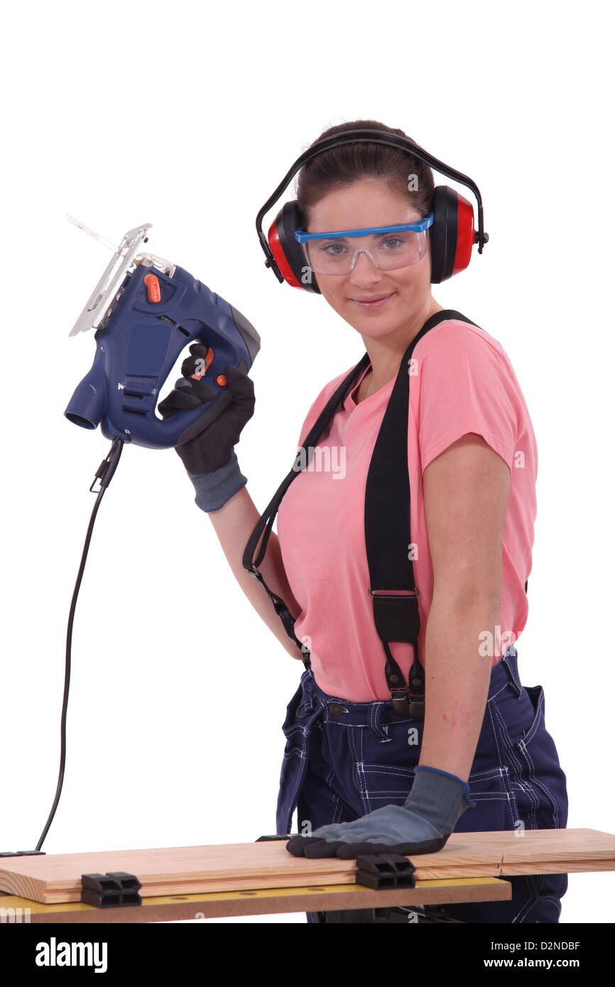 Woman using an electric saw Stock Photo - Alamy
