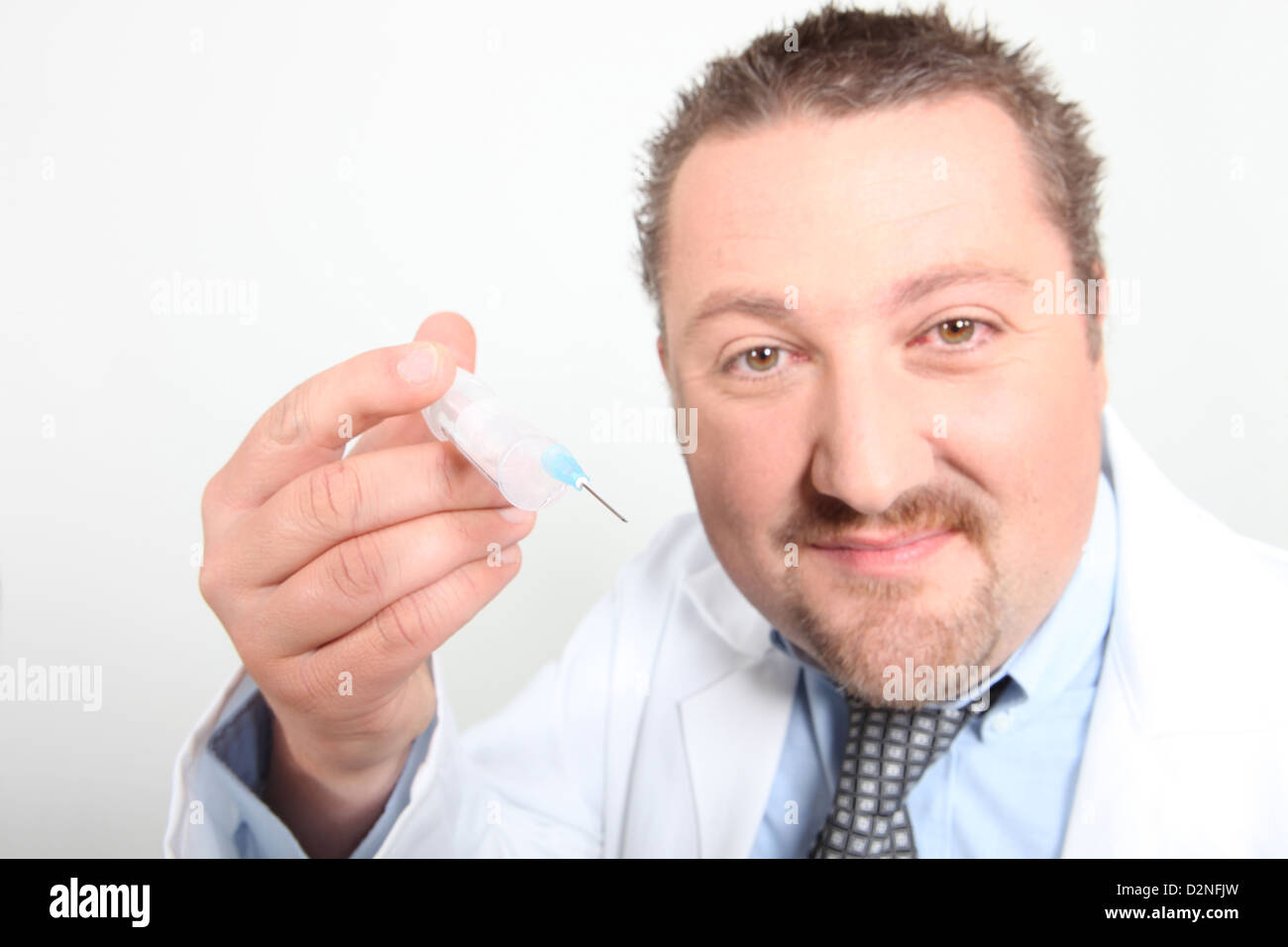 Male doctor holding syringe Stock Photo - Alamy