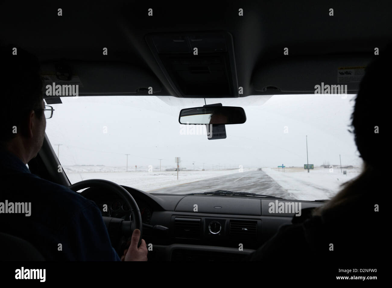 snow blowing over road while winter driving along Saskatchewan highway ...