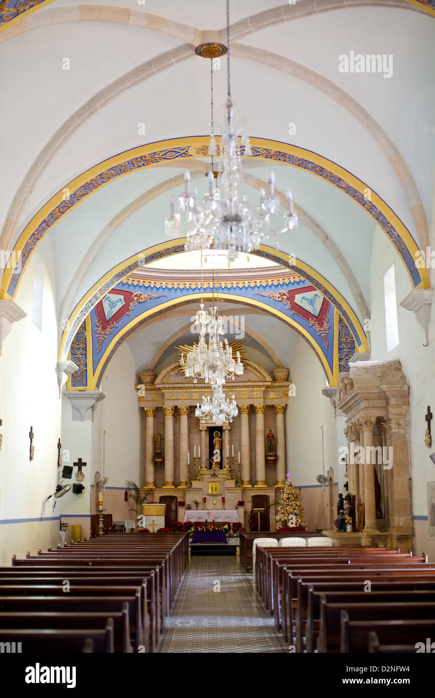 Historic church interior with ornate altar and chandeliers in Mexico ...
