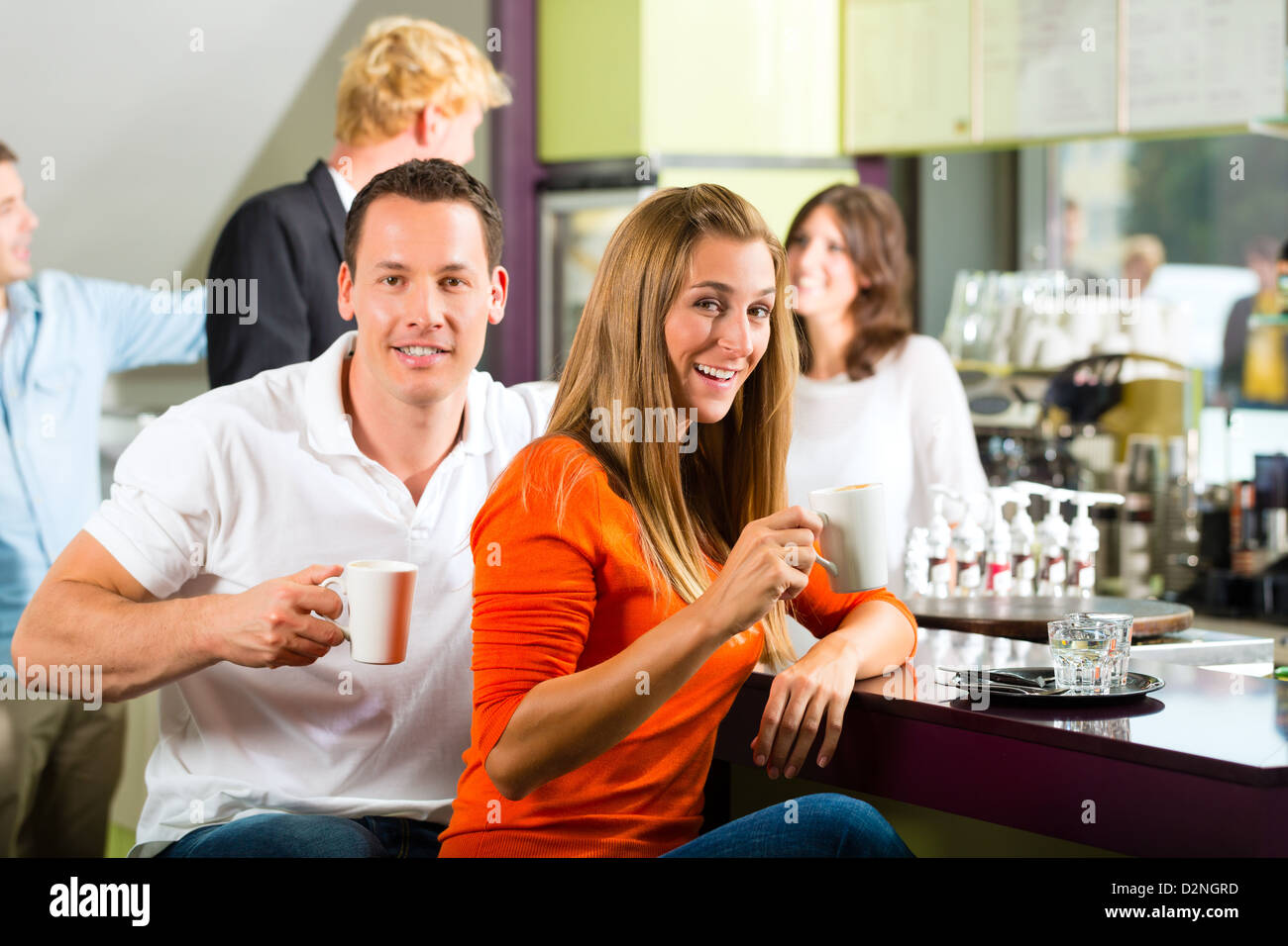 Group of people in Cafe drinking coffee sitting on bar or counter of ...