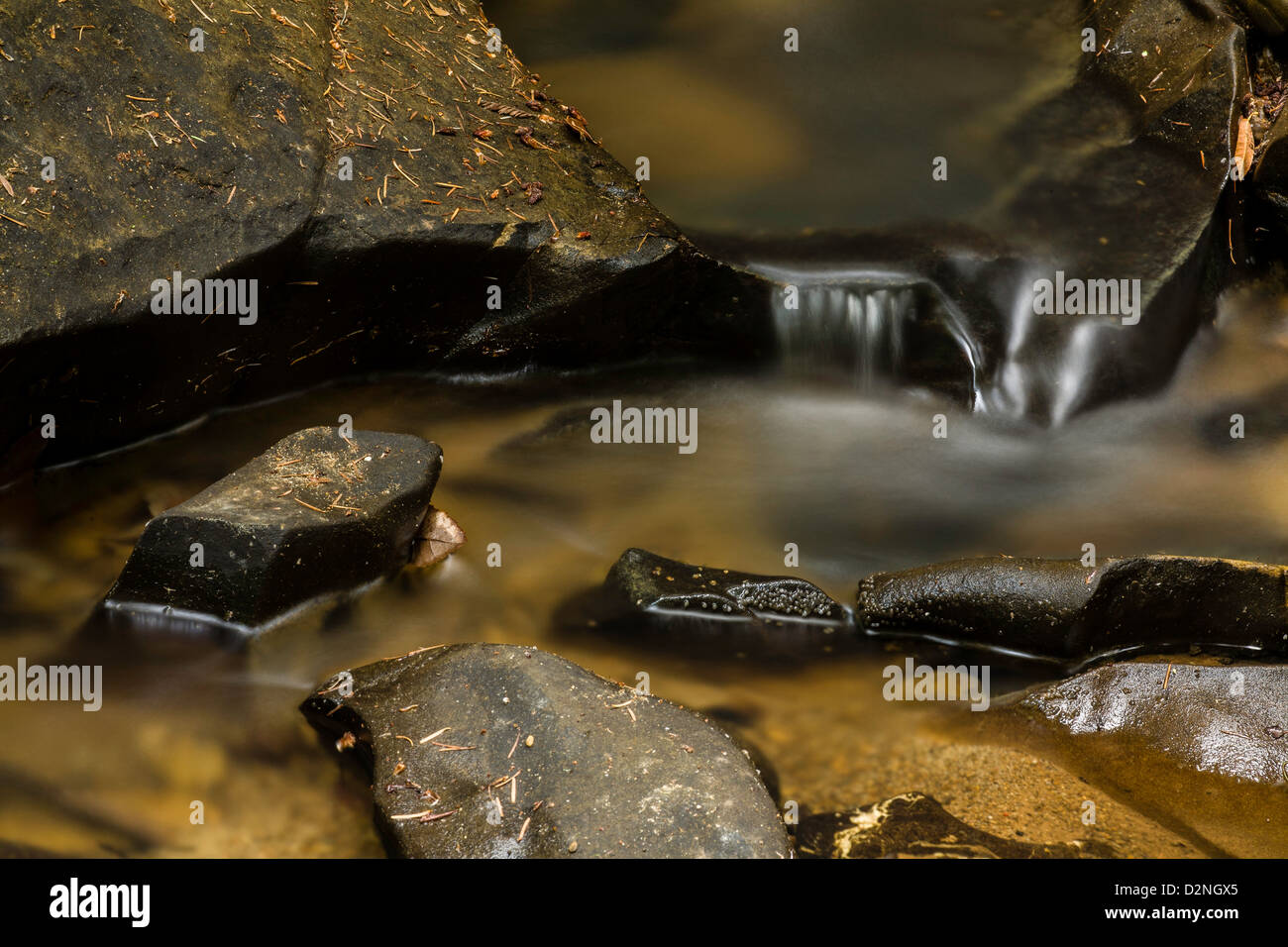 Stream of water flowing over rocks Stock Photo - Alamy