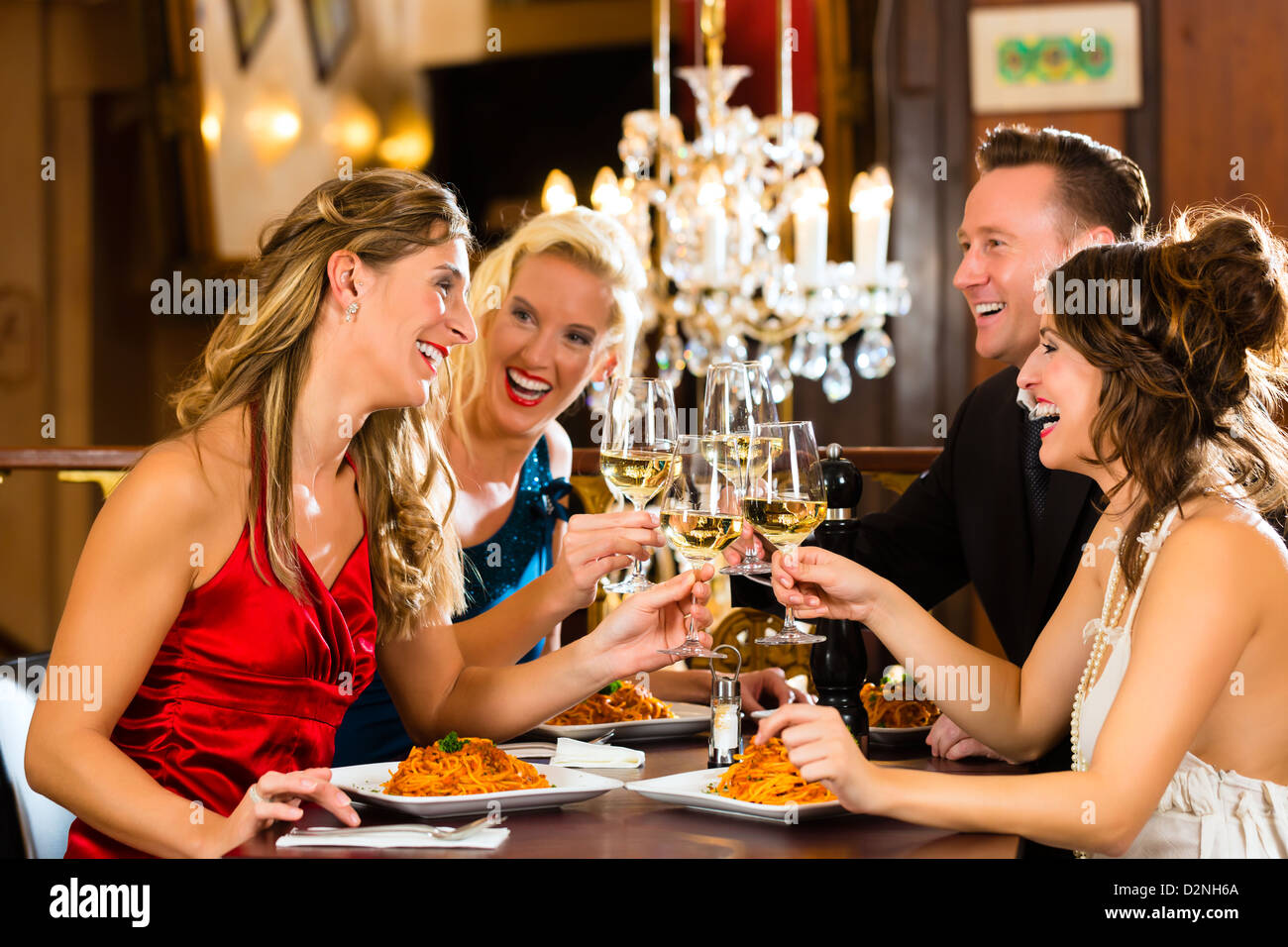 Good friends for dinner or lunch in a fine restaurant, clinking glasses ...