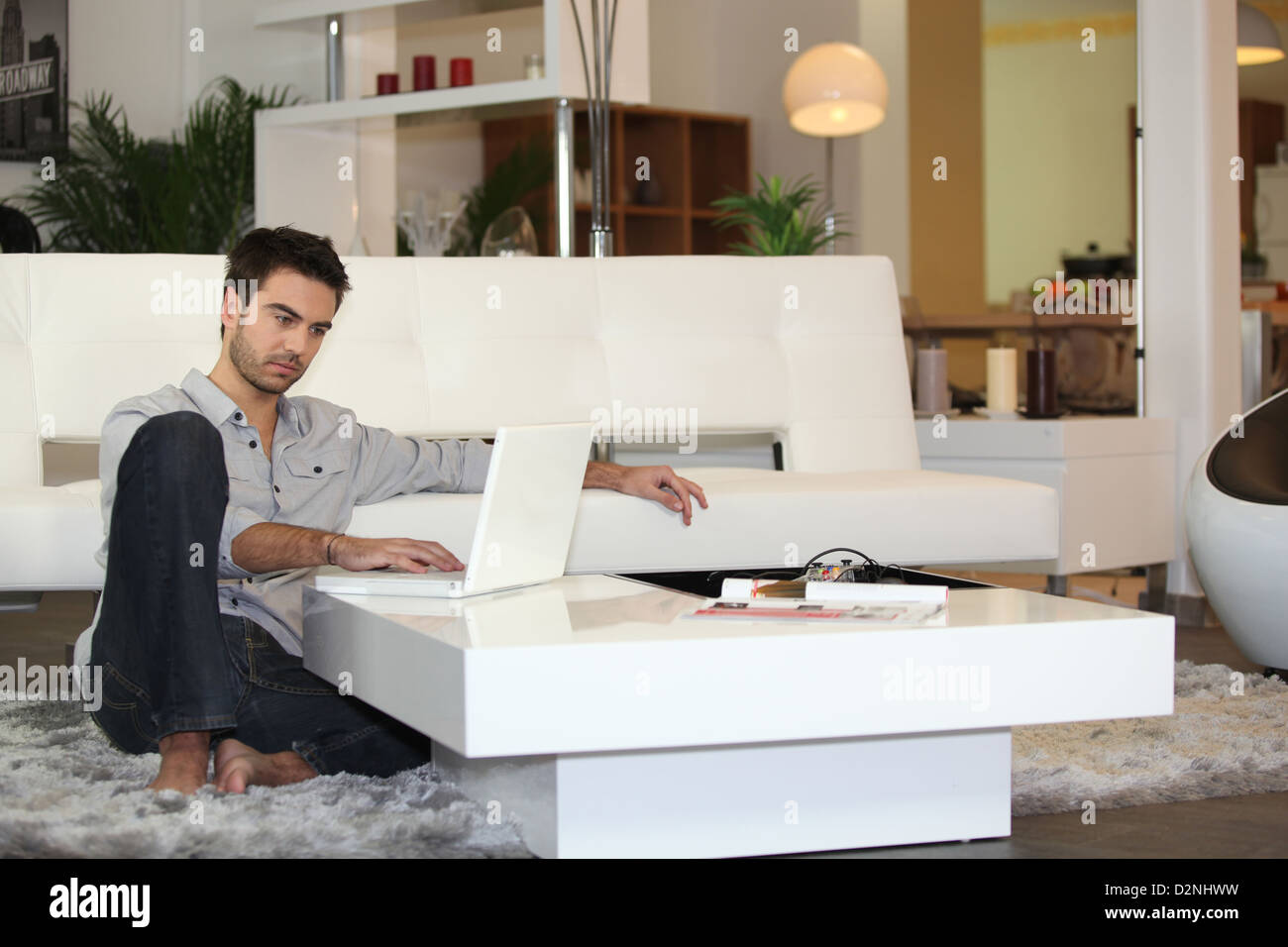 Attractive man using a laptop Stock Photo - Alamy