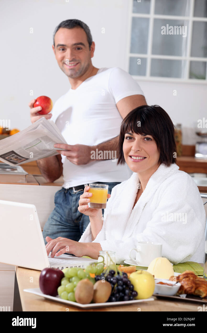 Couple having breakfast in the kitchen Stock Photo - Alamy