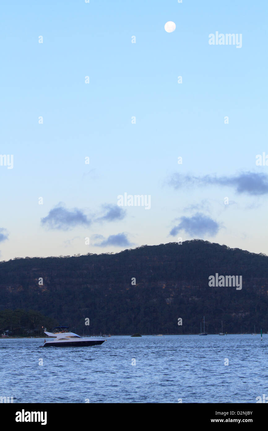 Boat with moon on top of a mountain as background Stock Photo - Alamy