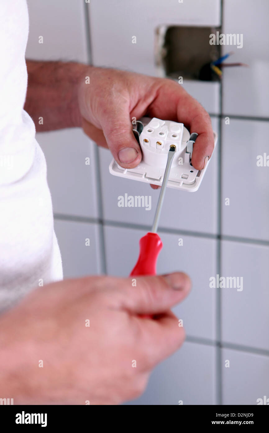 Electrician connecting plug Stock Photo - Alamy