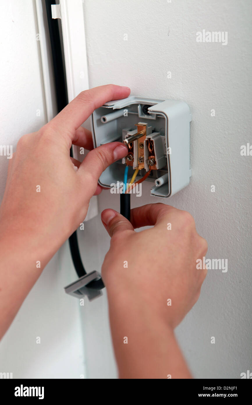 Electrician repairing wall socket Stock Photo - Alamy