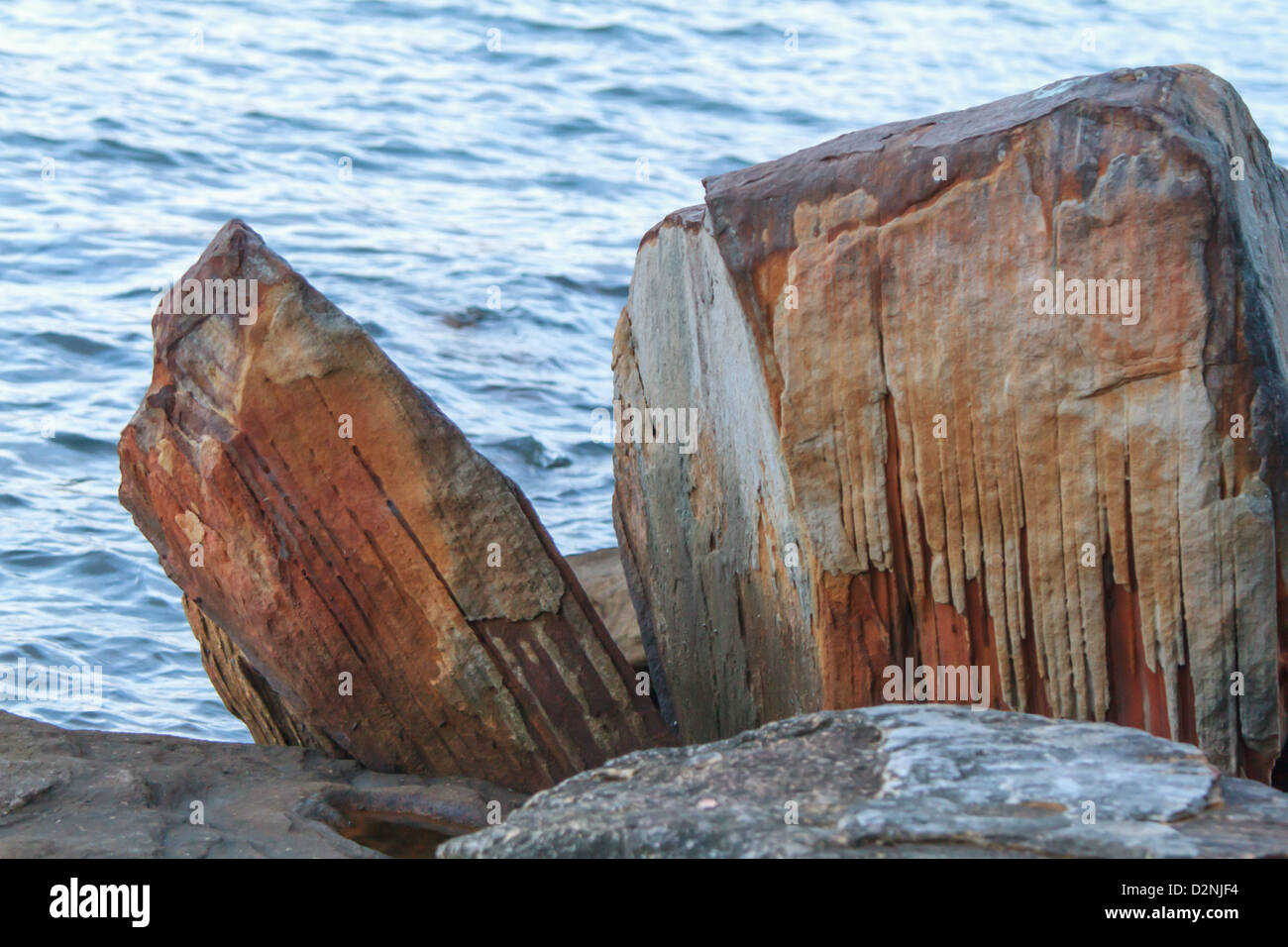 Big rocks cut into two line a tree log Stock Photo - Alamy