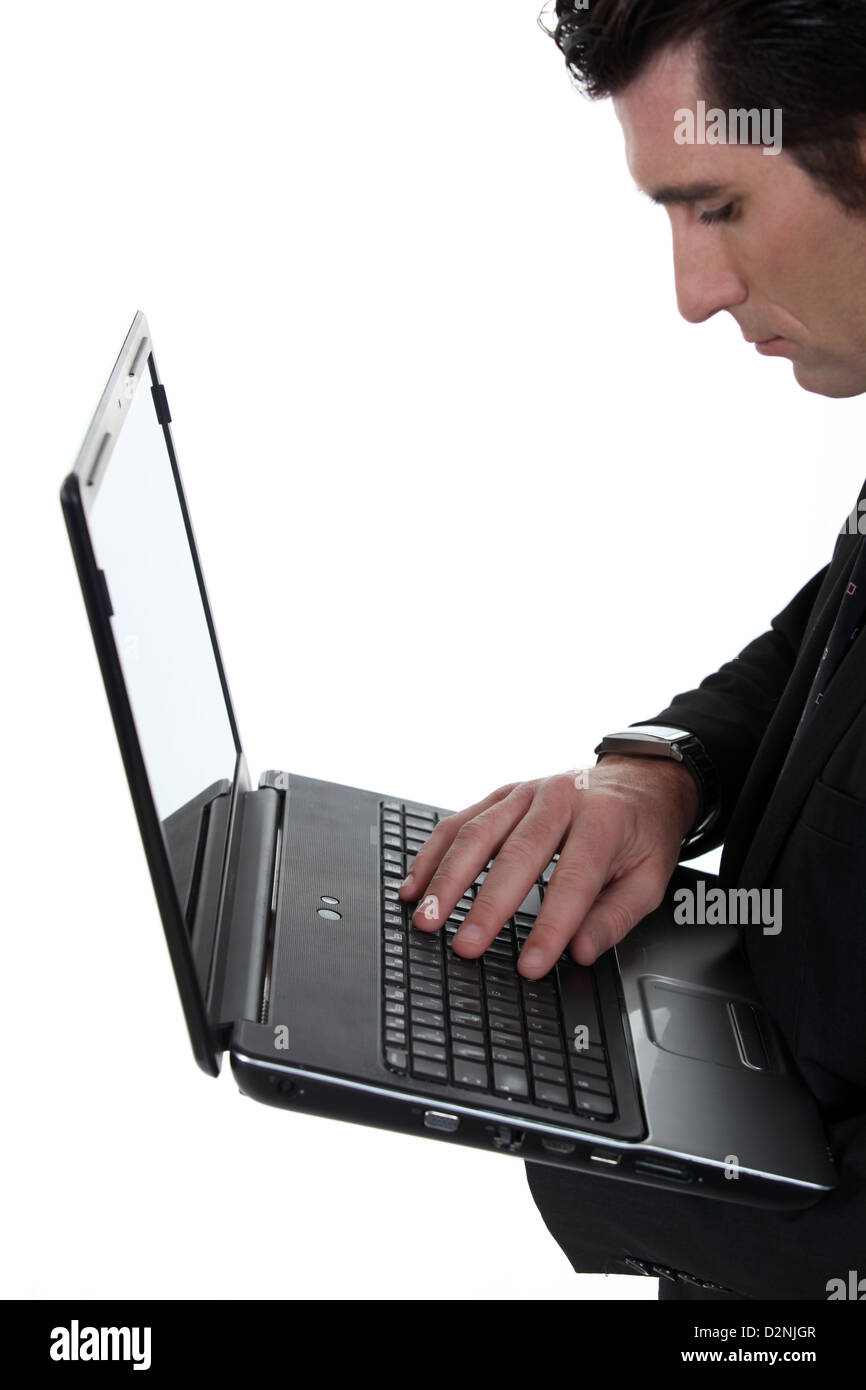 Office worker holding laptop Stock Photo - Alamy