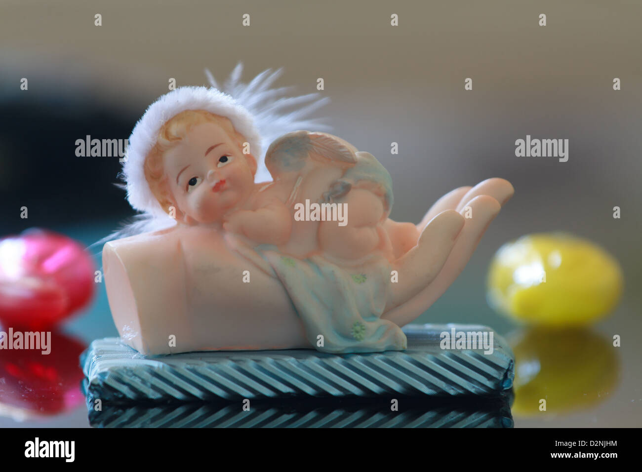 Little angel in a hand as a Christian baptism gift items Stock Photo ...