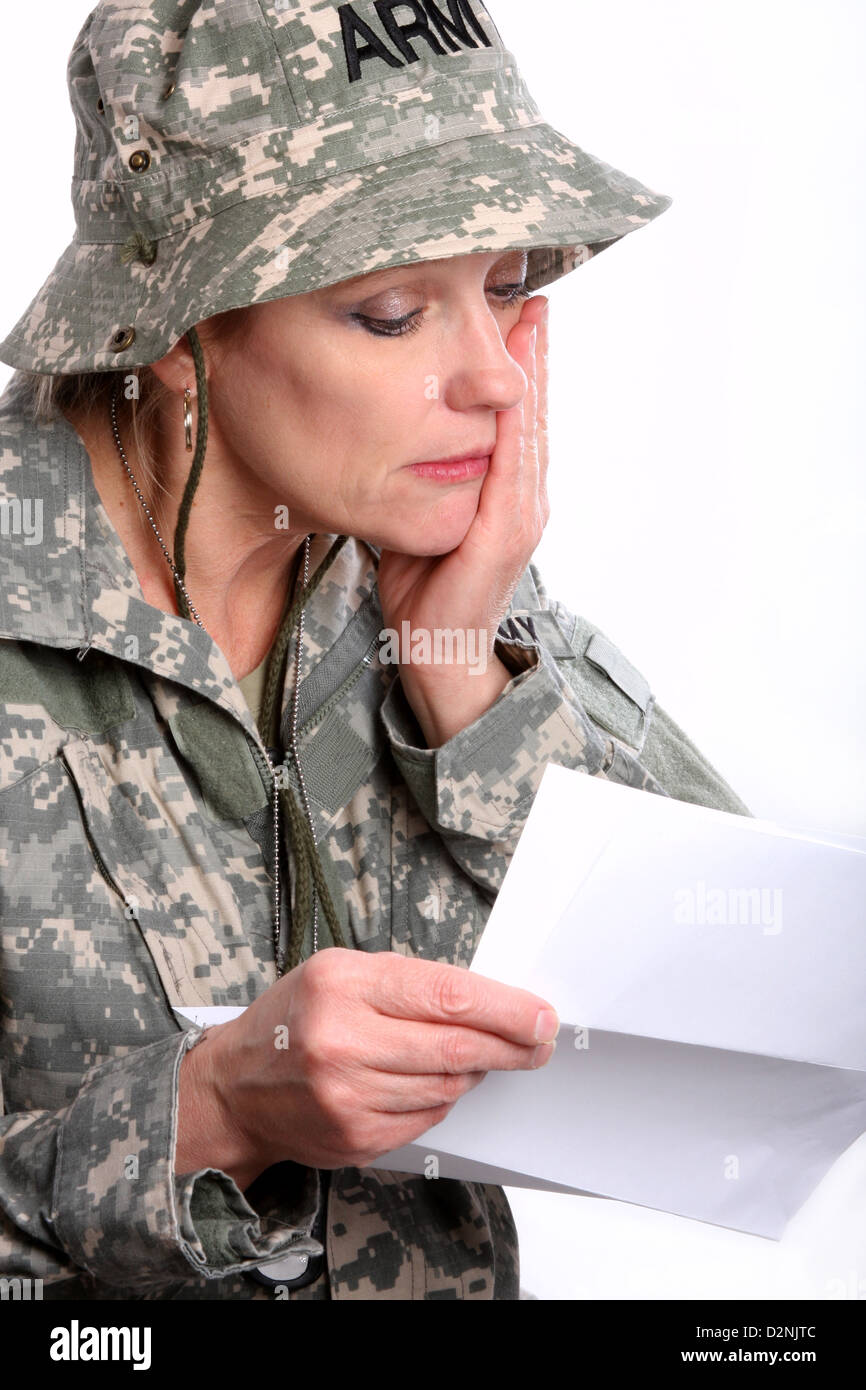 A sad USA military woman soldier reading a letter from home Stock Photo ...