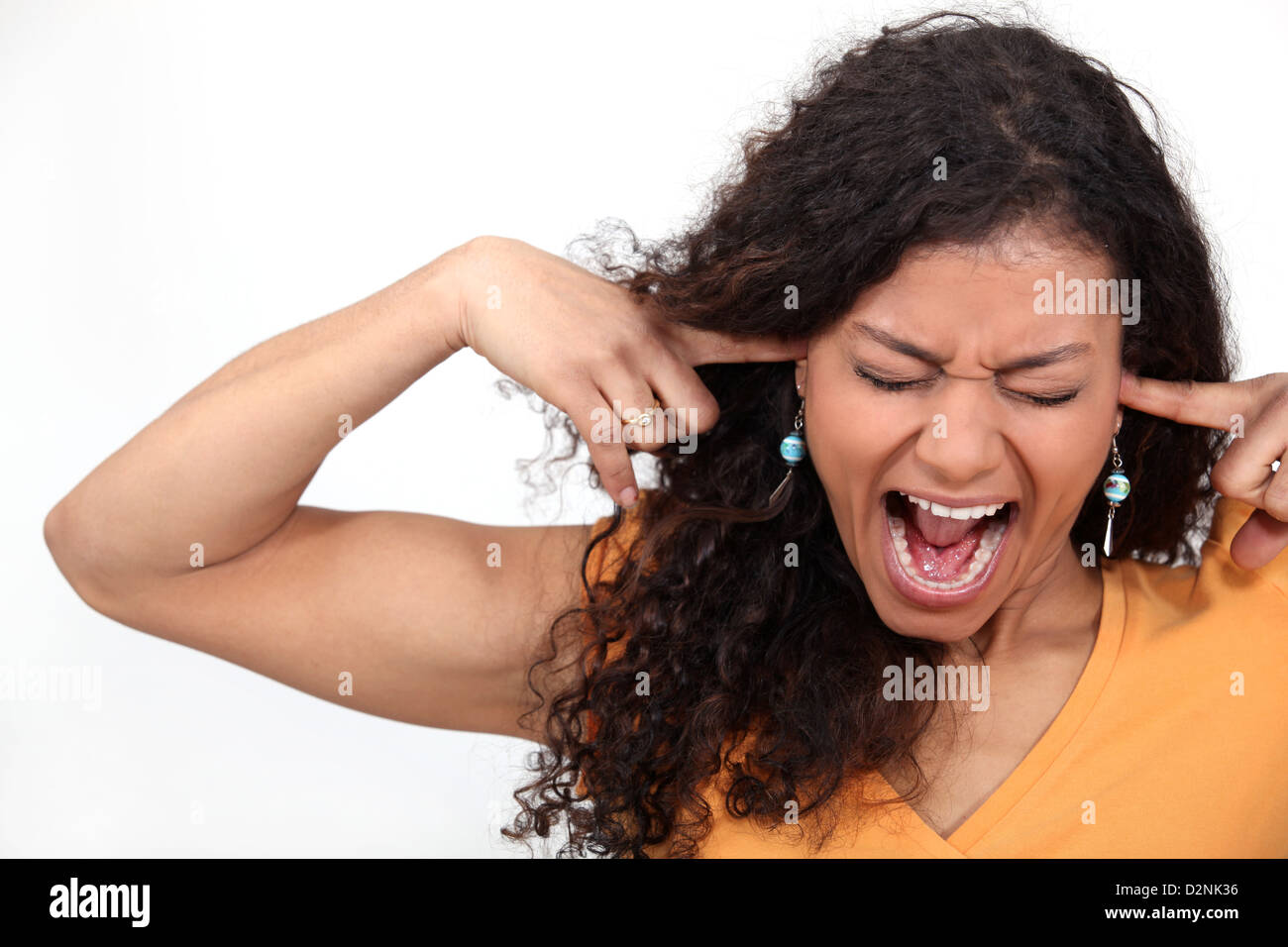 An African American woman plugging her ears Stock Photo - Alamy
