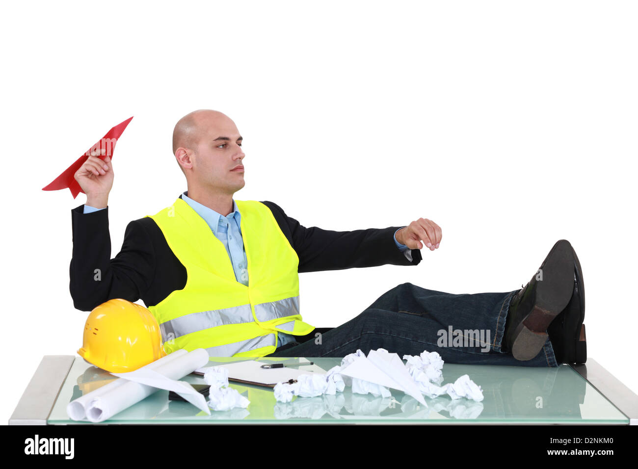 Bored foreman throwing paper airplane Stock Photo - Alamy