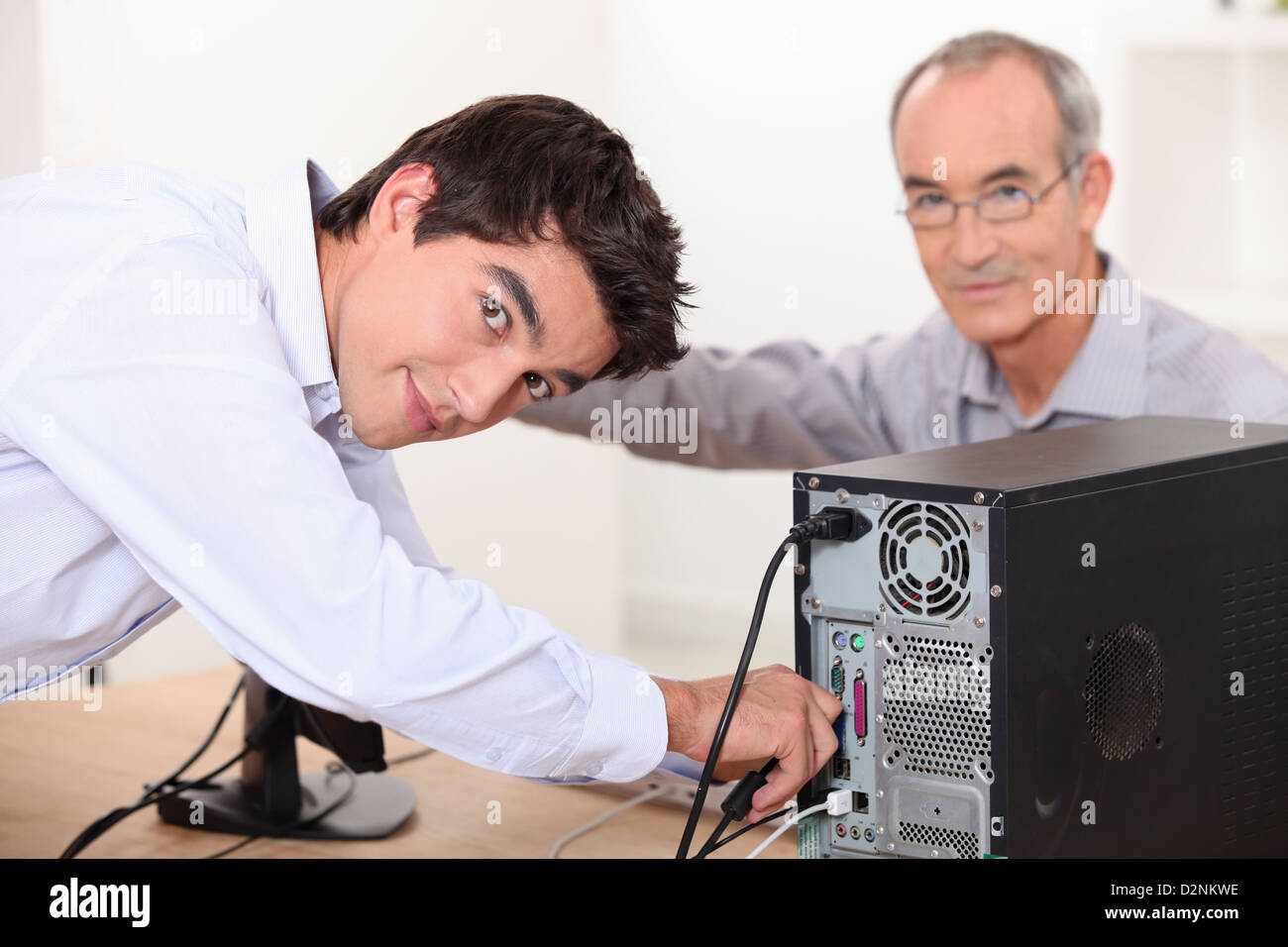 Computer fixing colleague hi-res stock photography and images - Alamy