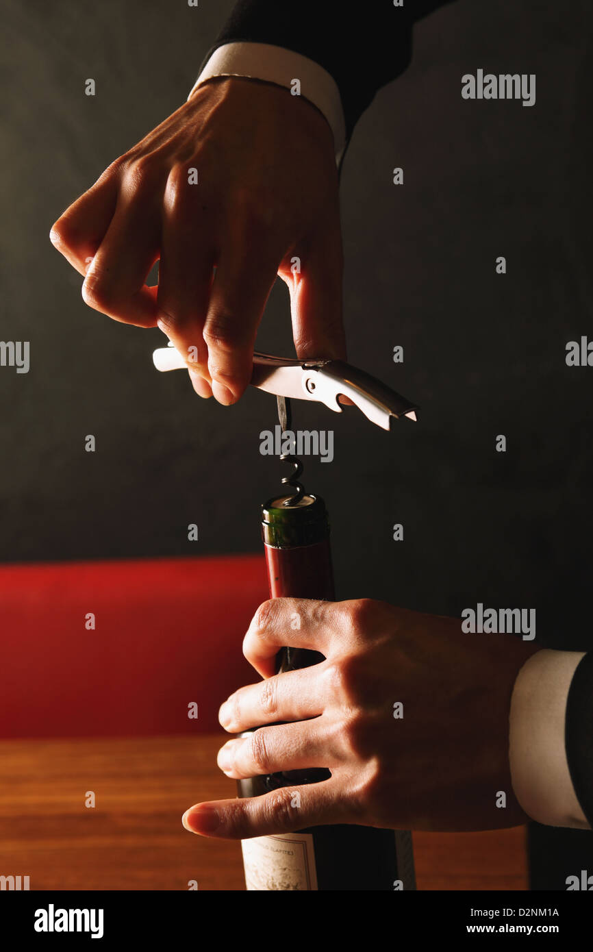 Sommelier opening a bottle of wine Stock Photo - Alamy