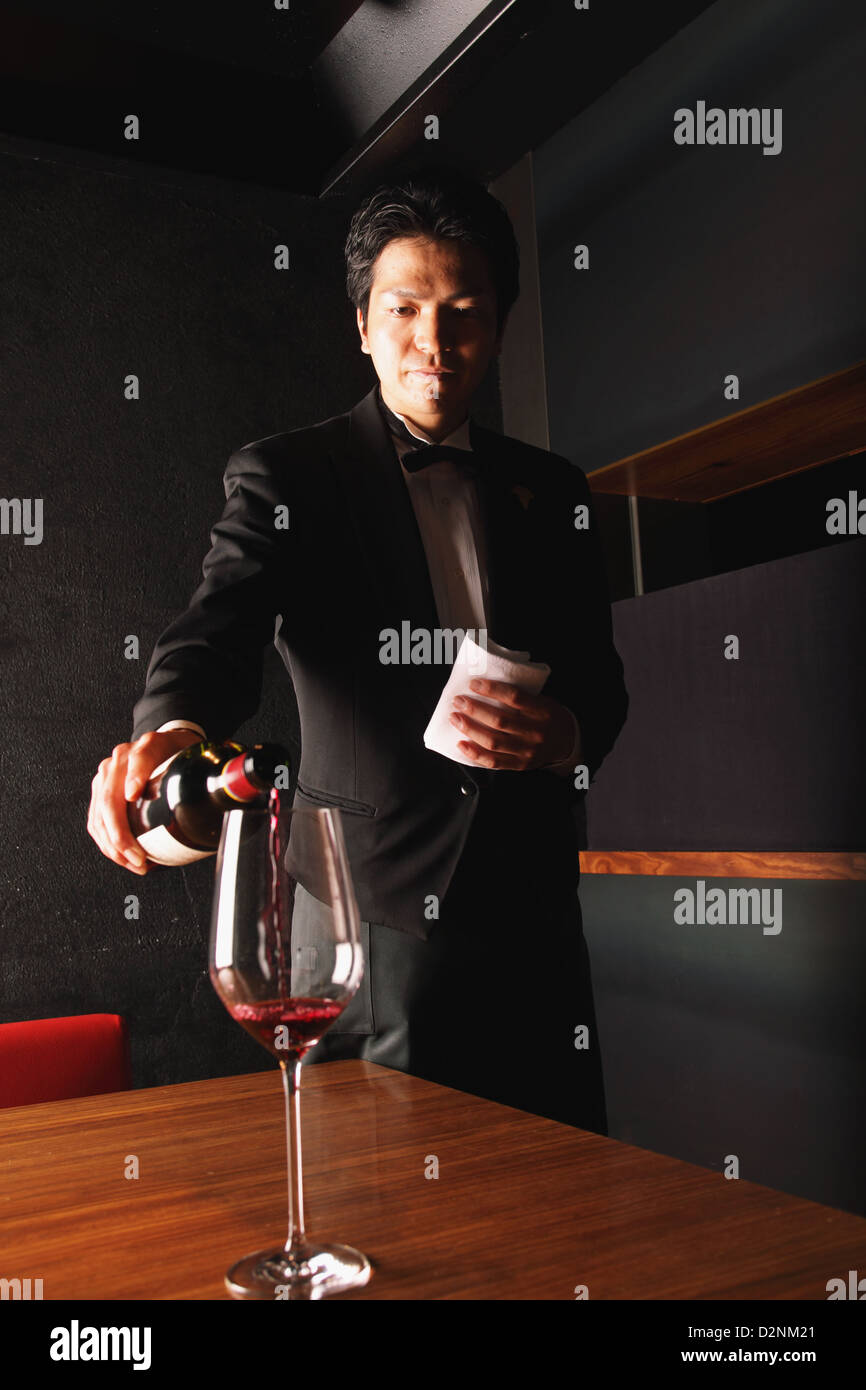 Sommelier serving red wine Stock Photo - Alamy