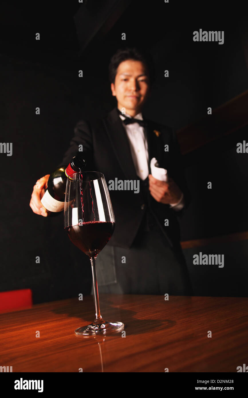Sommelier serving red wine Stock Photo - Alamy
