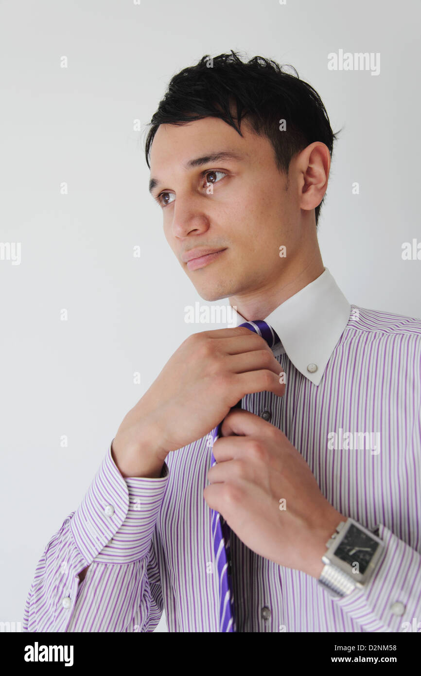 Side view businessman fastening hi-res stock photography and images - Alamy