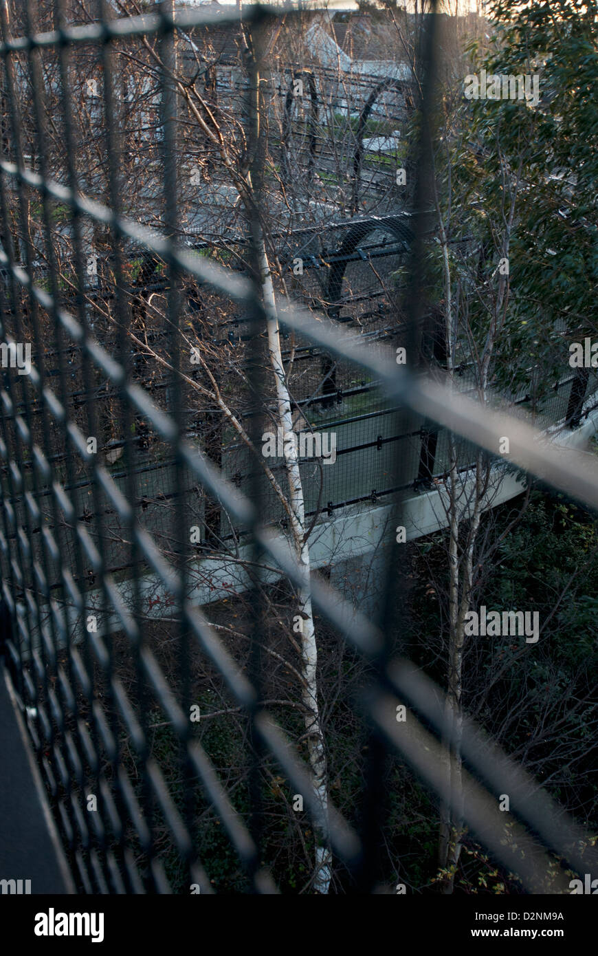 View through the cage surrounding a pedestrian walkway over dual ...