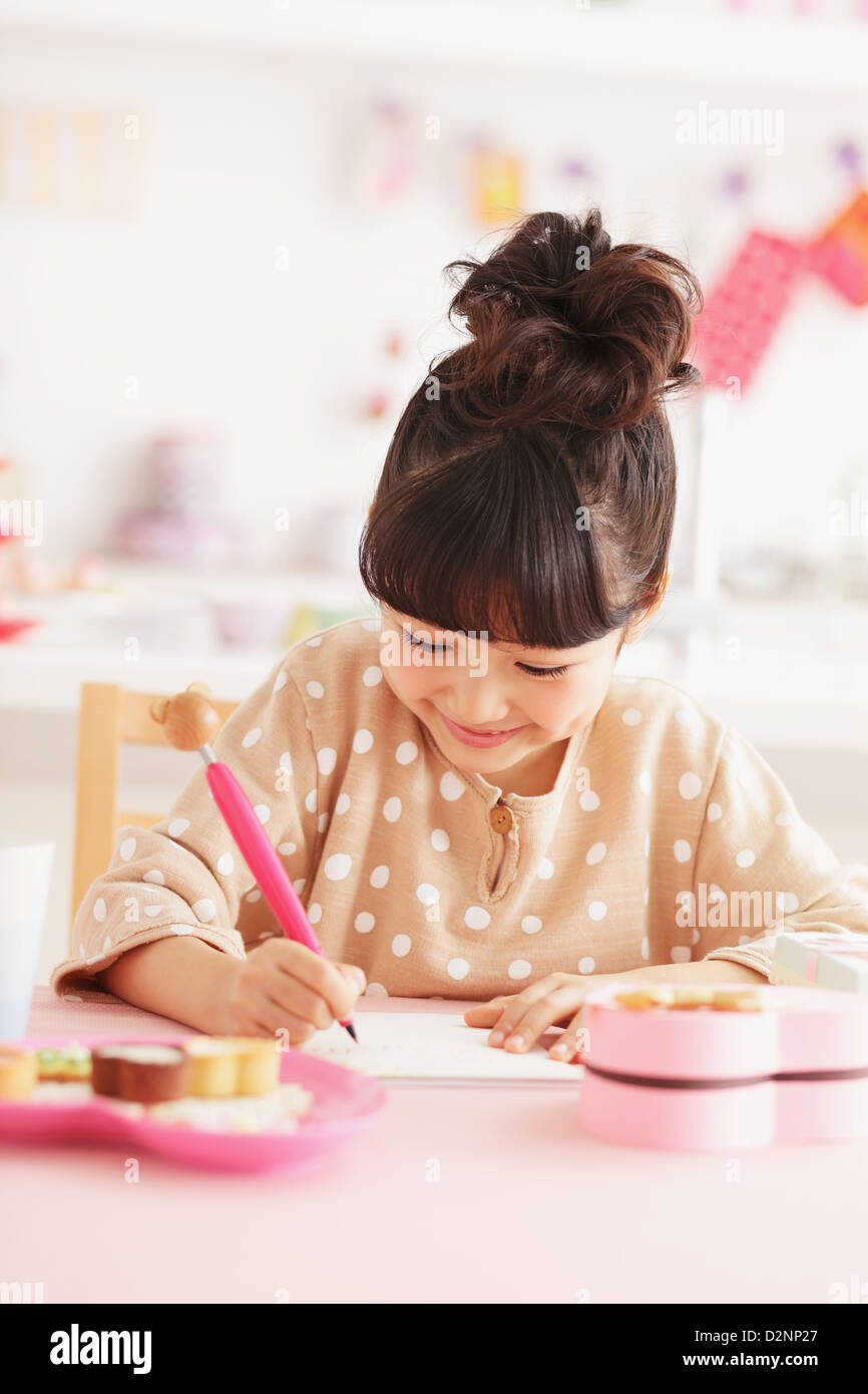 Young girl writing at her desk Stock Photo - Alamy