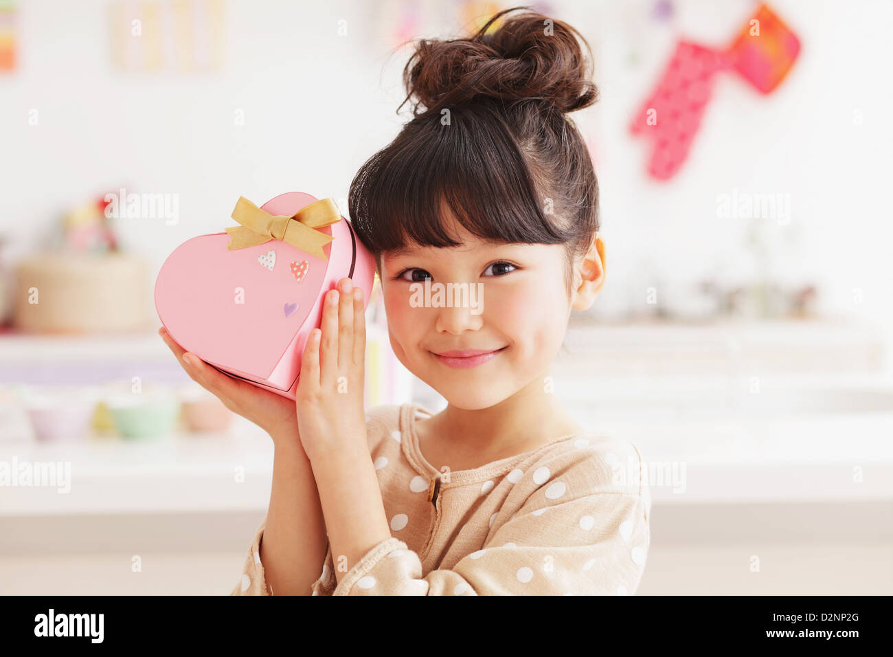 Young girl with chocolate box smiling at camera Stock Photo - Alamy