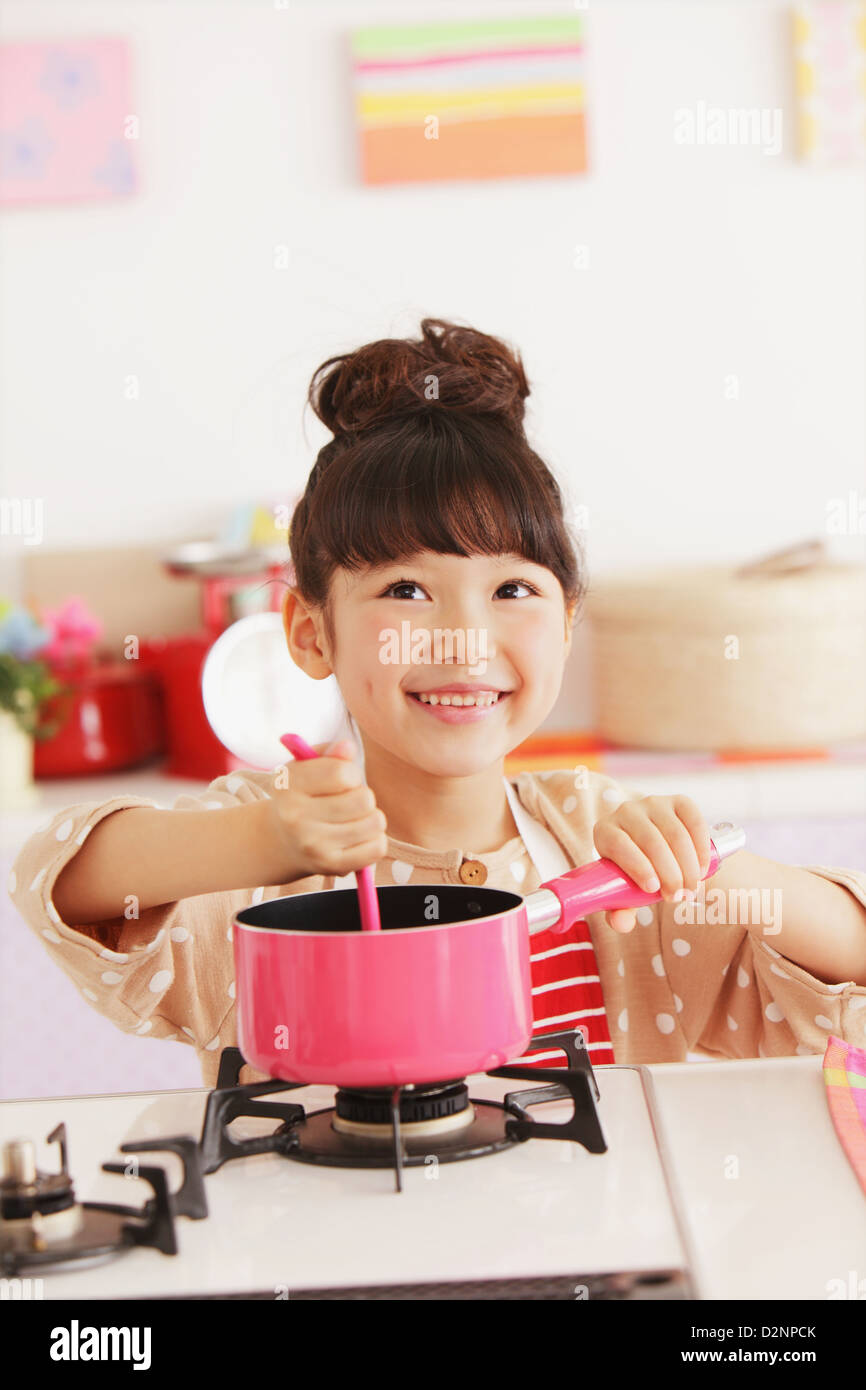 Young girl cooking in a colorful kitchen Stock Photo - Alamy