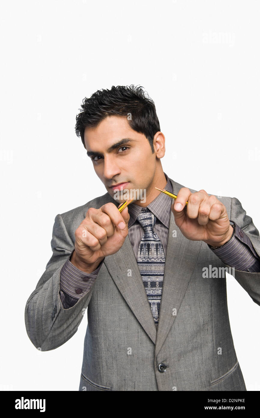 Portrait of a businessman breaking a pencil Stock Photo - Alamy
