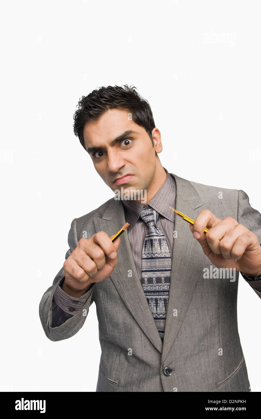 Portrait of a businessman breaking a pencil Stock Photo - Alamy