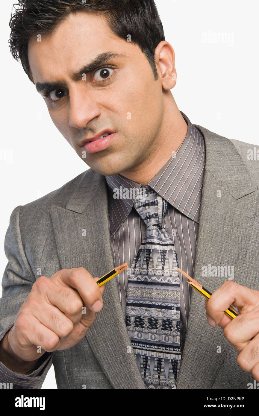Portrait of a businessman breaking a pencil Stock Photo - Alamy