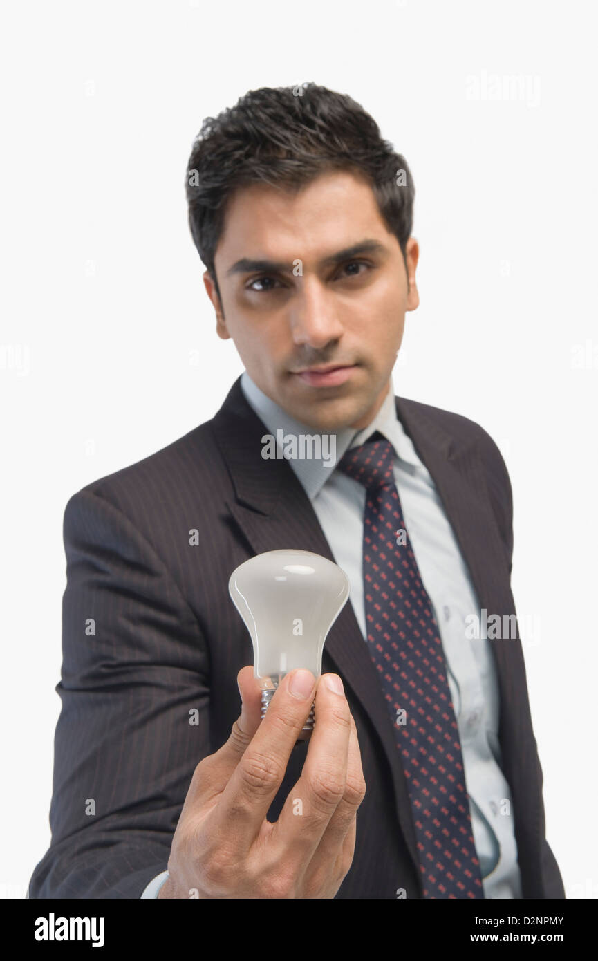 Portrait of a businessman showing a light bulb Stock Photo - Alamy