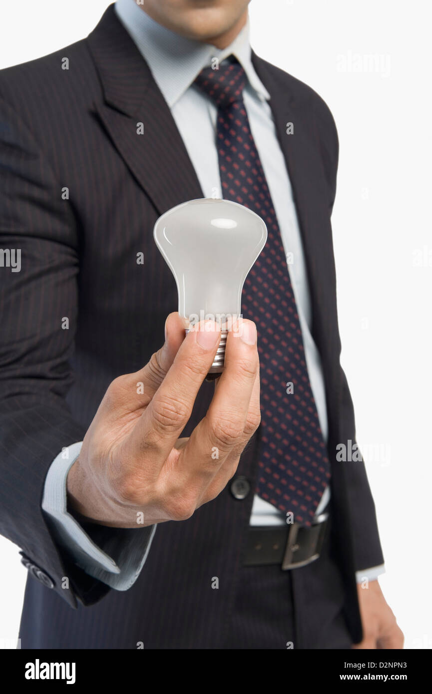 Mid section view of a businessman showing a light bulb Stock Photo - Alamy